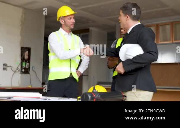 Architect or engineer and foreman construction workers shaking hands ...