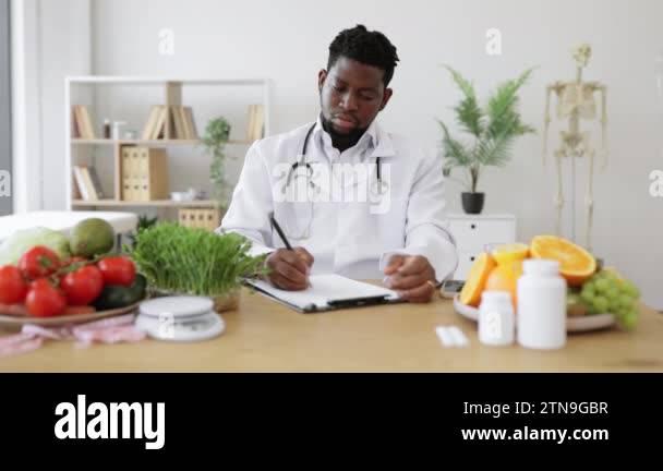 Doctor gastroenterologist filling patients case history and prescribing ...