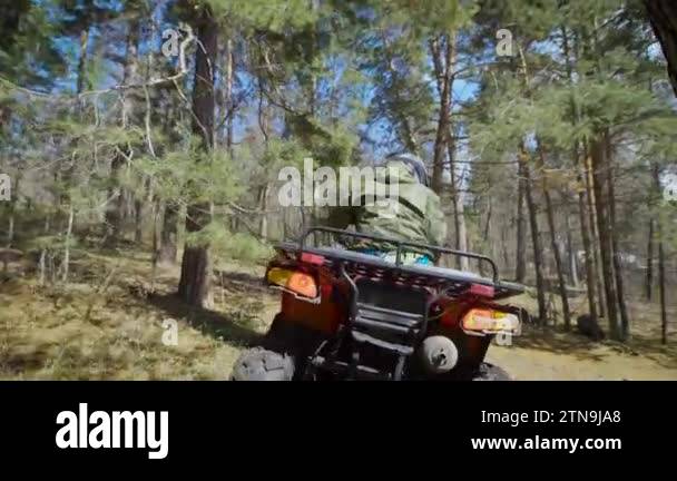 Extreme vacation in the woods on the ATV. Men engage in motor sport ...