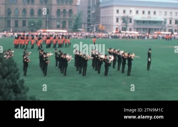 Group of soldiers marching to sound of music played by military band in ...