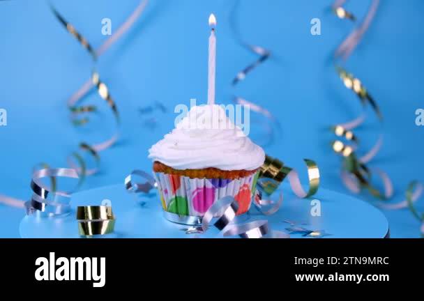 Rotating birthday cake for a boy or man or a cupcake with a burning ...