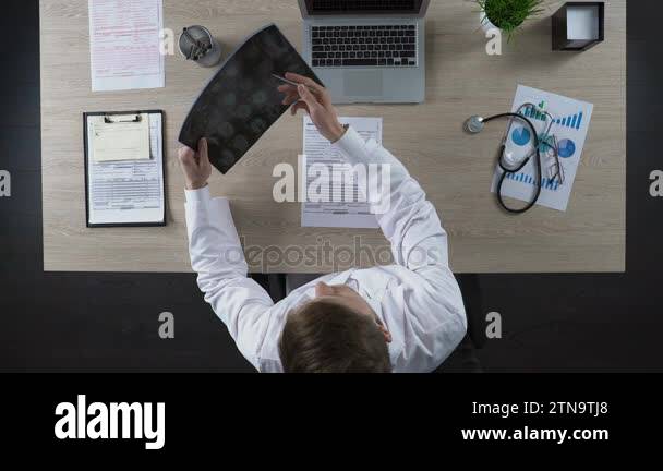 Surgeon analyzing human brain MRI scan, medical tests for diagnostics ...