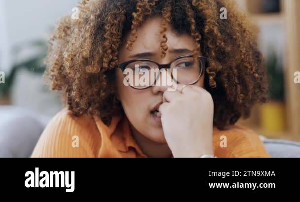 Anxiety, worry and nail biting by black woman on a sofa with fear ...