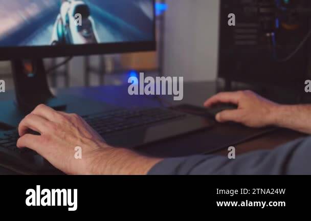 Unrecognizable male gamer using mouse and keyboard while playing fps on ...