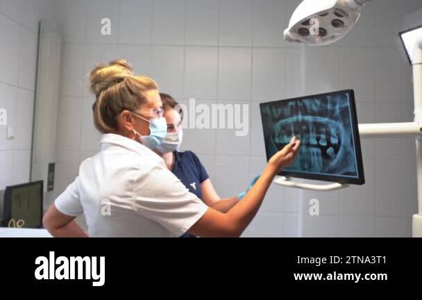 Dentist hand explore study teeth mouth cavity x-ray on monitor describe ...