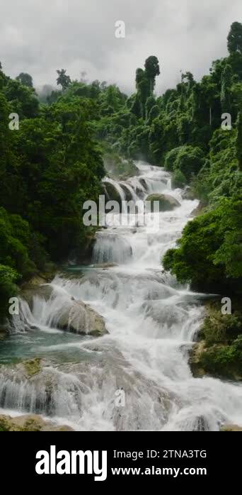 Top view of Beautiful waterfall in green forest. Highest Aliwagwag falls in the Philippines ...