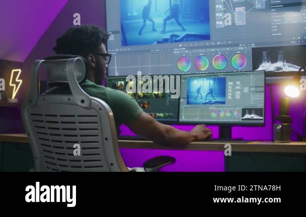African American video maker edits action movie, makes color grading ...