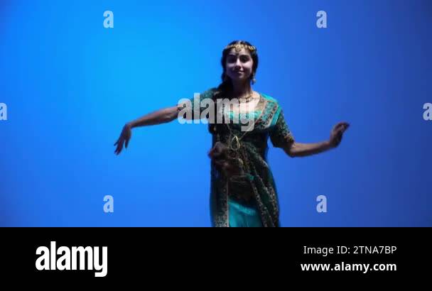 Young Indian woman moves and grooves to the beat of traditional Indian ...