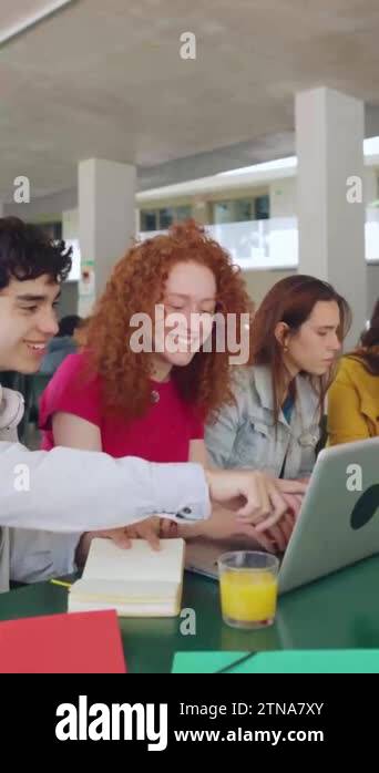 Young group of high school students studying together with laptop ...