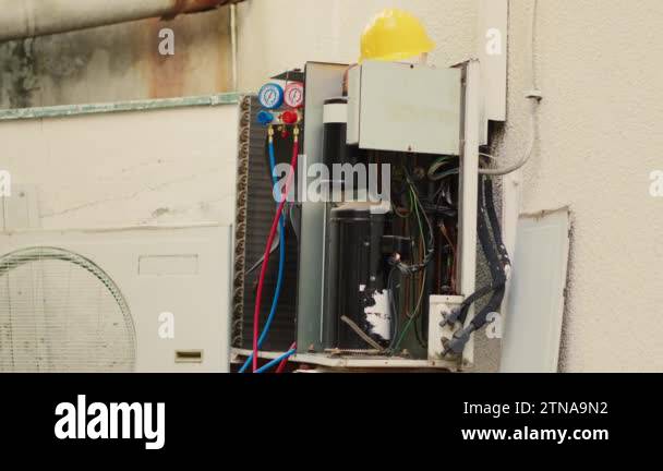 Defective outside air conditioner system with protection cover removed ...