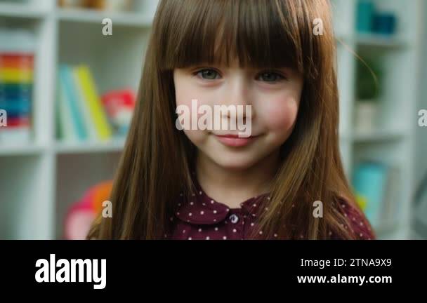 Face portrait close up. Beautiful little girl looking at the camera and ...