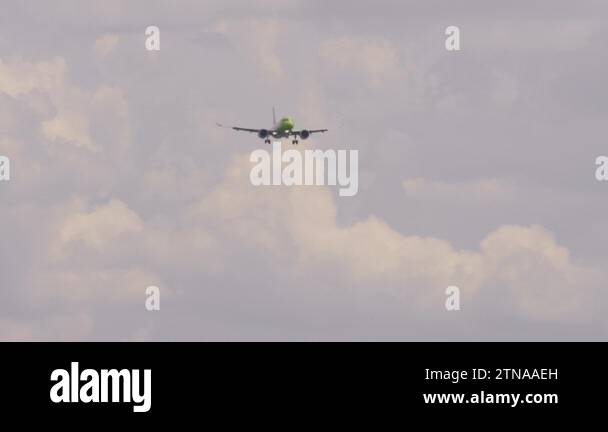 Passenger plane approaching for landing. Aircraft flies, front view ...