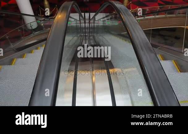 Close-up shot of empty moving staircase running up and down. Modern ...