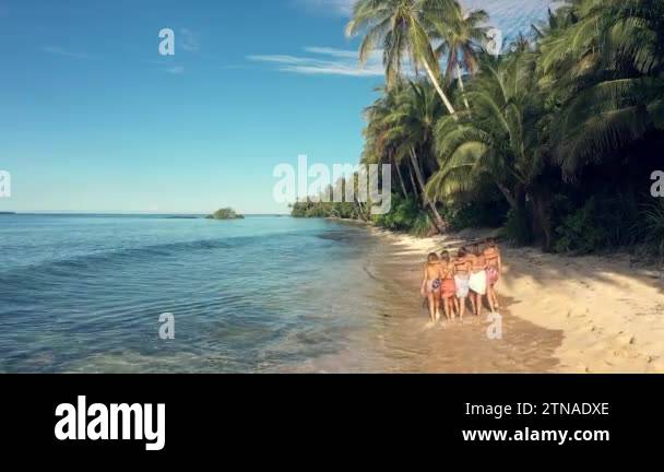 Island, aerial and women walking on beach for adventure, holiday and ...