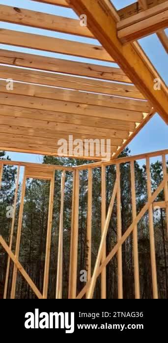 Building wooden house begins with framing beams which support layout of ...