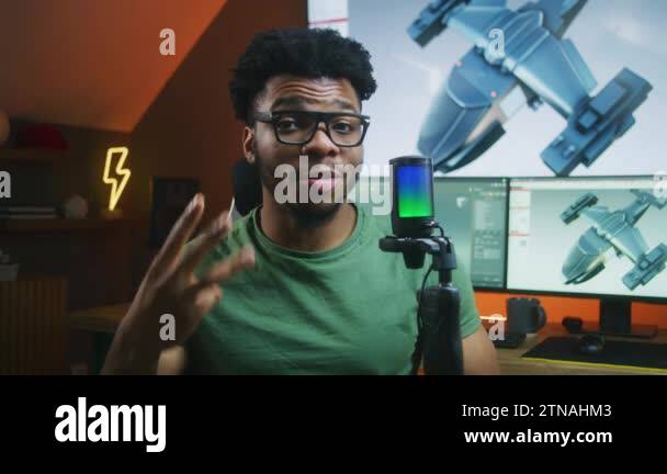African American 3D designer speaks on camera using microphone, records ...