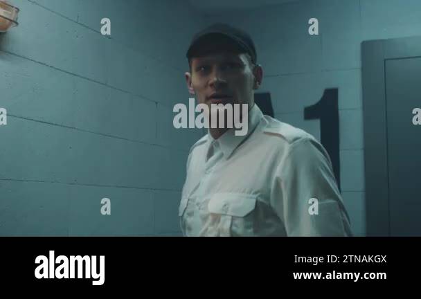 Cinematic shot of prison officer talking to criminal, attacking him ...