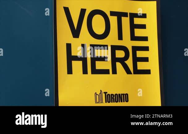 vote here capital letters in black on yellow background with toronto ...