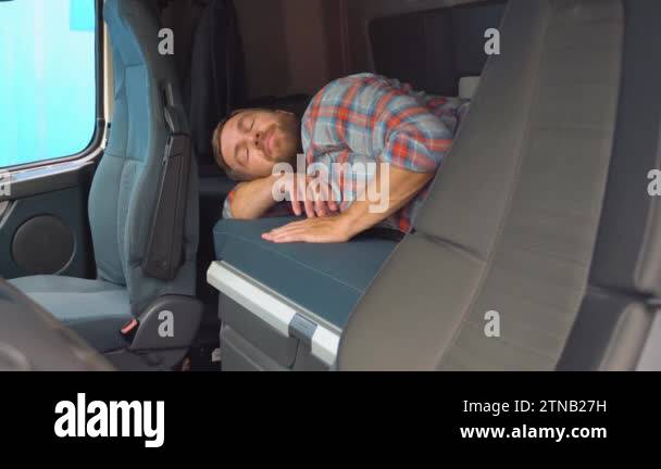 Truck driver sleeping in his cabin after working long routes overtime ...