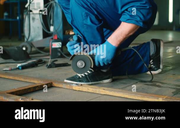 Auto mechanic on autoservice background in blue uniform and helmet ...