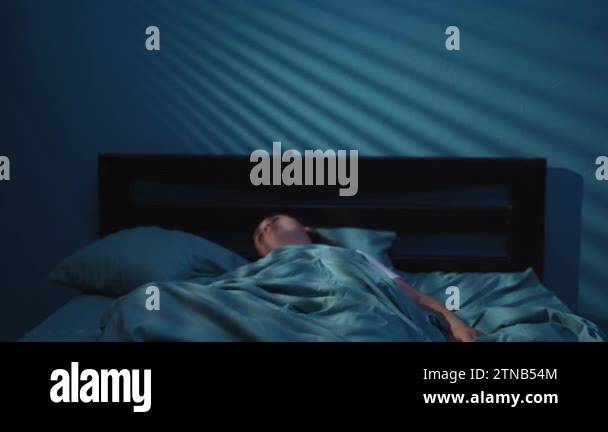 Insomnia and nightmare concept. Shocked scared woman waking up from a ...