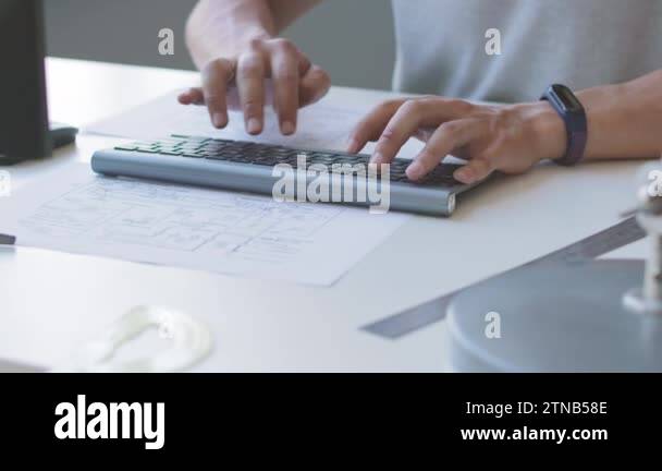 Unrecognizable engineer or architect looking at technical drawing on ...