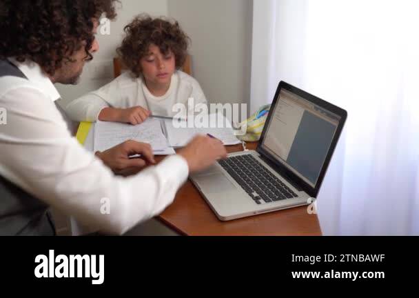 Father and son 9-year-old elementary school boy doing homework - doing school-given math ...