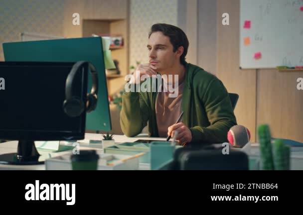 Serious designer working computer in home office. Closeup focused ...