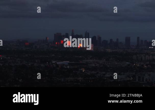 Aerial slide and pan of distant downtown skyscrapers. High rise office ...