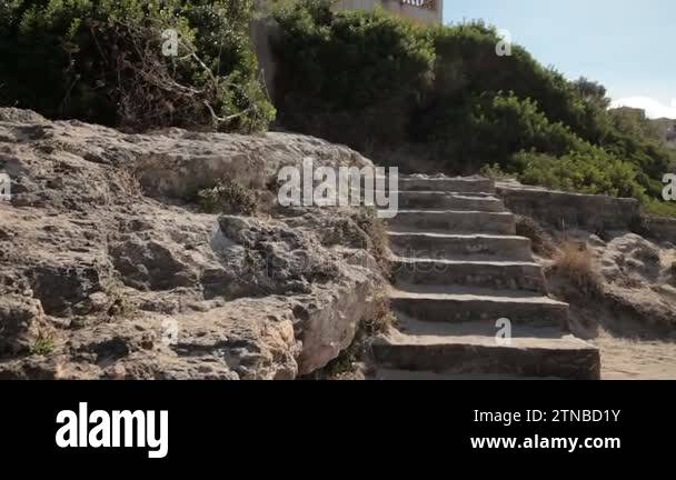 Paths and stairs along the slopes of the rocks along the beach. Spanish ...
