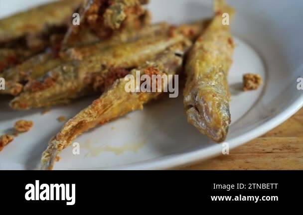 Whole small fish battered with herb and flour then deep fried to make ...