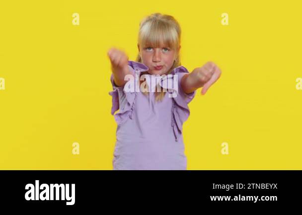 Dislike. Upset young preteen child girl kid showing thumbs down sign ...