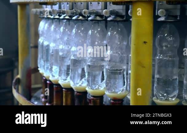 Production of drinking mineral water in plastic bottles. Close-up of ...