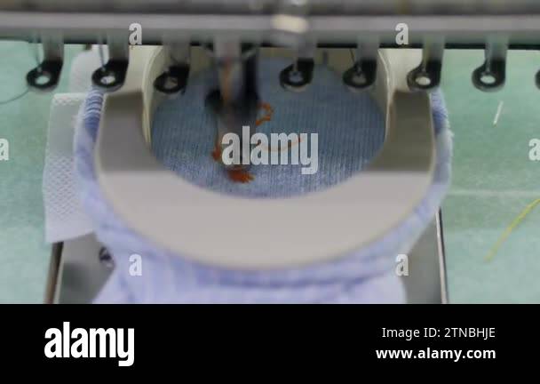 Embroidering a pattern on a sock. Automatic sock stitching at garment ...