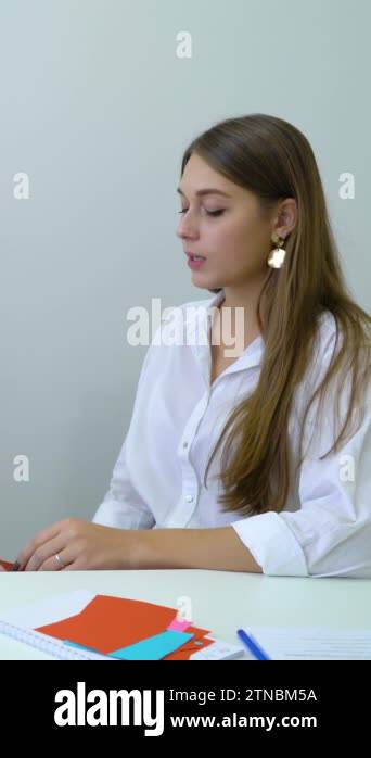 Vertical Screen: high school student sitting in classroom and having ...