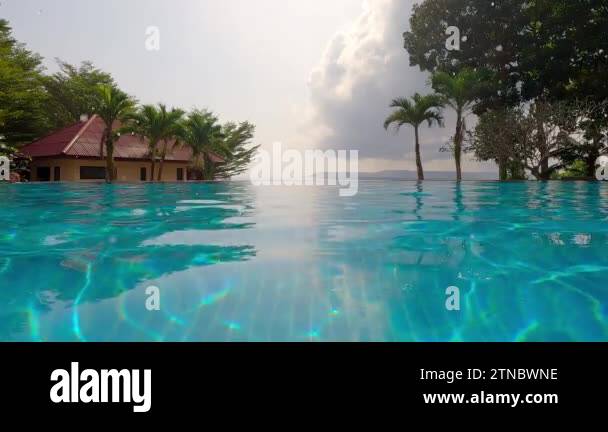 A video of a boy doing a cannonball jump in the infinity pool located ...