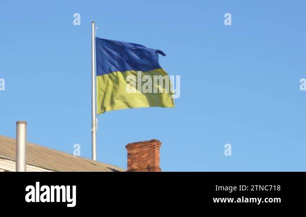 motion of Ukraine flag waving background sky blue and yellow national ...