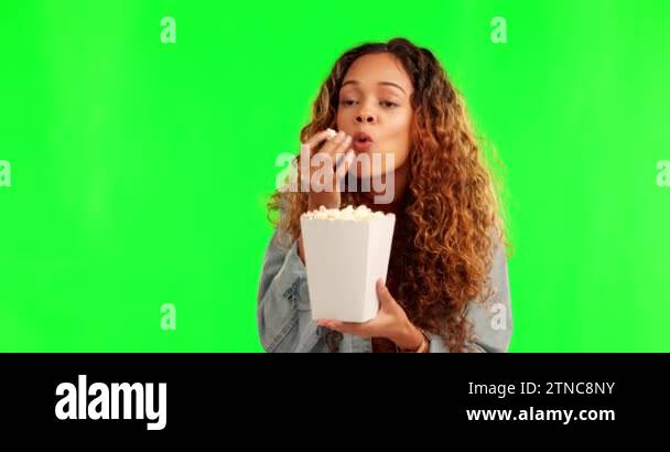 Excited woman, popcorn and green screen eating movie snack and watching ...
