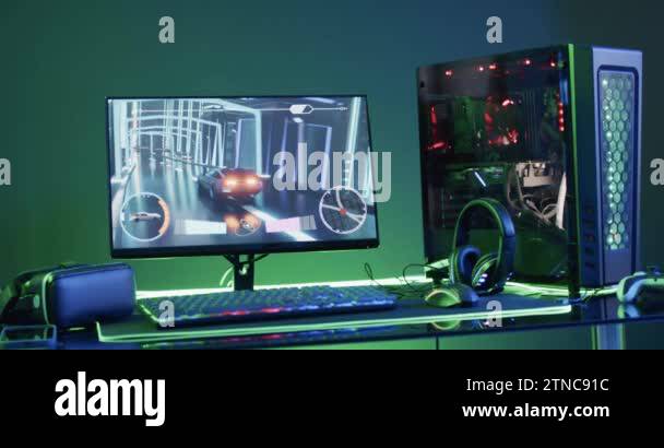Video of computer and gaming equipment on desk with copy space on neon ...