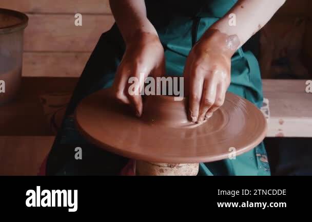 Creating a clay pot.Gonchar.Potter.A turner.Workshop of clay.Clay on the device.Master.Hands ...