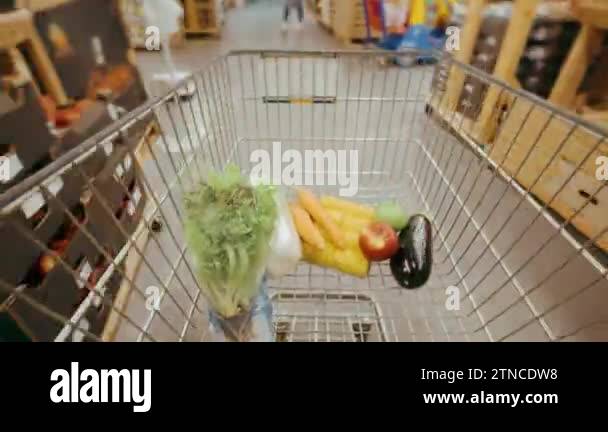 Timelapse of filling a shopping cart with various food products in a ...