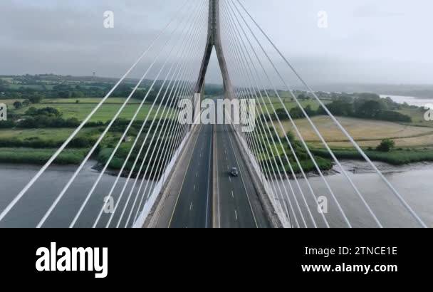 Two cars drive across the bridge towards the camera. Cable-stayed ...