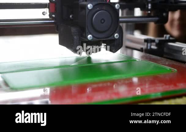 3D printer printing prototype of toy from molten plastic. Process of ...