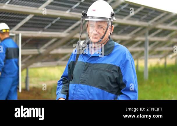 Two Service Engineers or electrician working on checking transformer ...