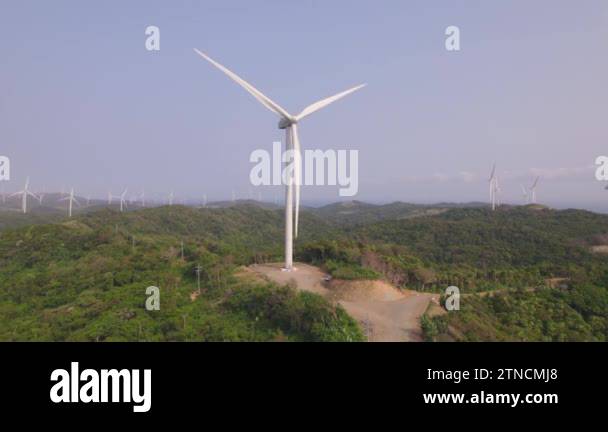 Multiple wind turbines operating during daytime in the Philippines ...