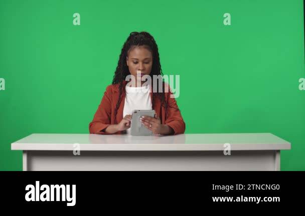 TV Live News Program. A professional TV presenter sits at a table in ...