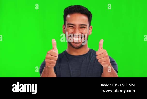 Face, thumbs up and happy man in green screen studio background with ...