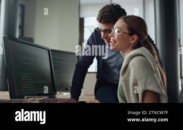 Smiling it intern discussing software code with supervisor. Friendly team work analyse problem ...