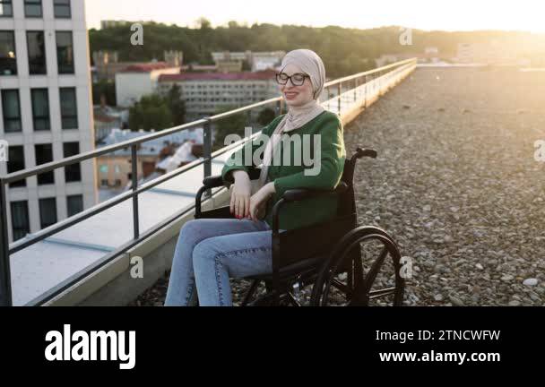 Portrait of cheerful young female with disability smiling at camera ...