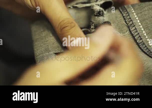 Man tailor hands making tears and holes in denim jeans with cutting needle Stock Video Footage ...